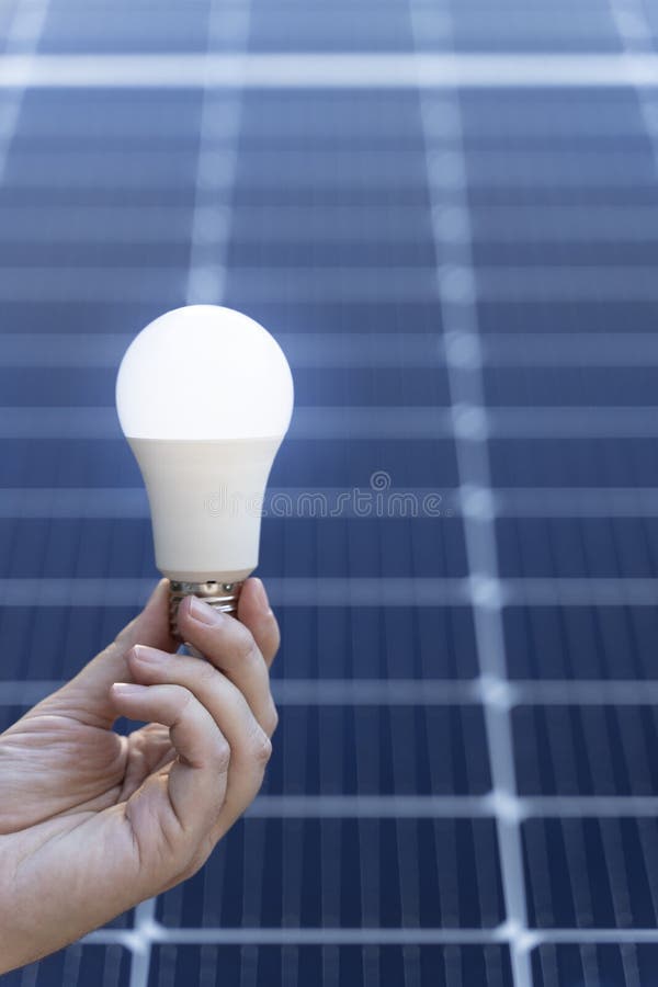 Energy Saving Concept with a Light Bulb and Solar Panels Stock Image ...