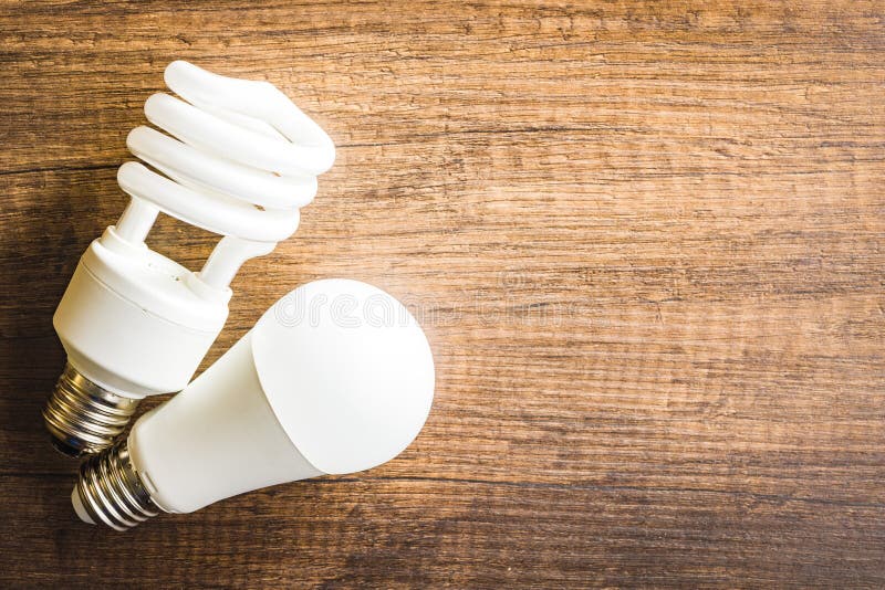 Energy Saving Light Bulb . Fluorescent and Led Lightbulb on Wooden ...