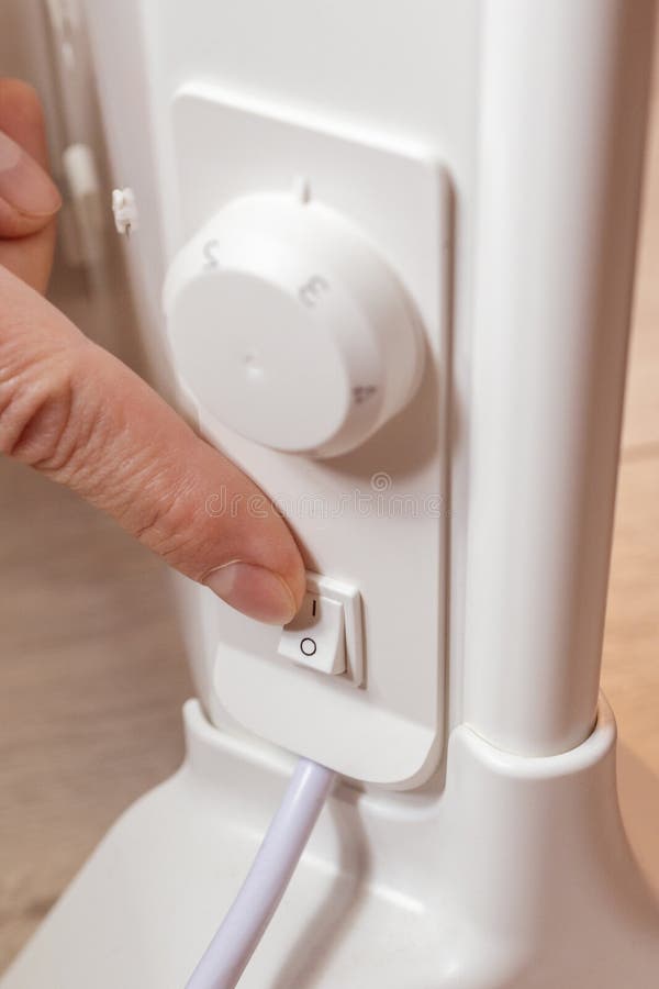 Energy Saving. Switch Off Button of the Electrical Appliance. Finger on ...