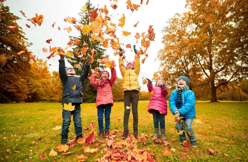 Enfants Heureux Jouant Avec Des Feuilles Dautomne En Parc Image Stock