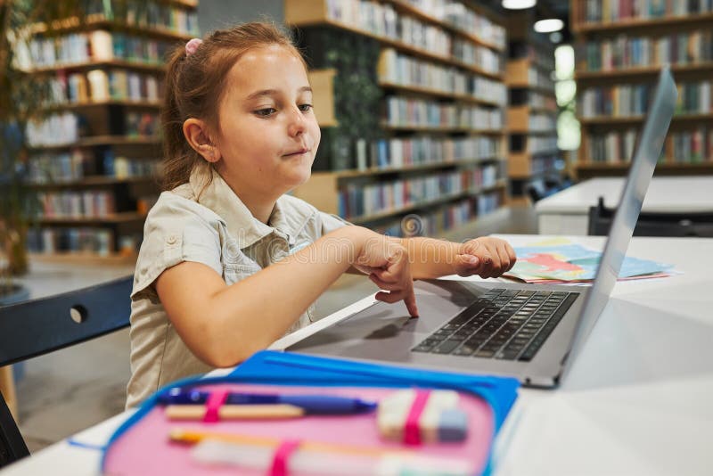 Engaged Student Doing Her Homework Using Laptop in after School Club at ...