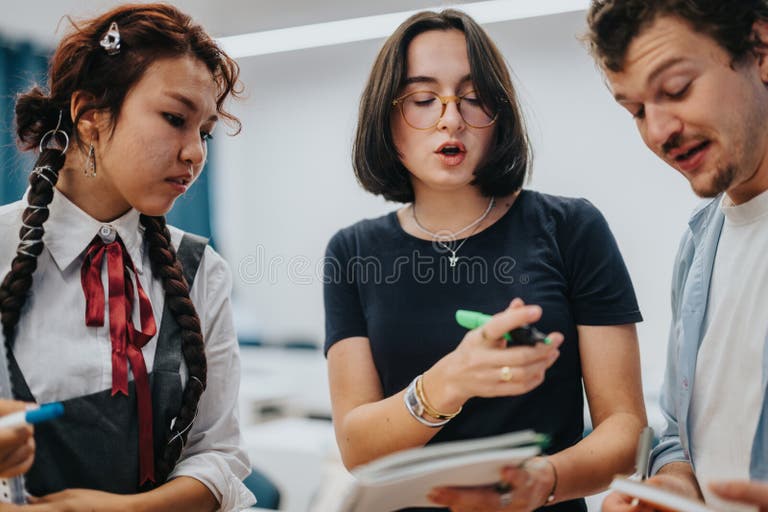 Engaged Students Collaborating on a Group Project in Classroom Stock ...