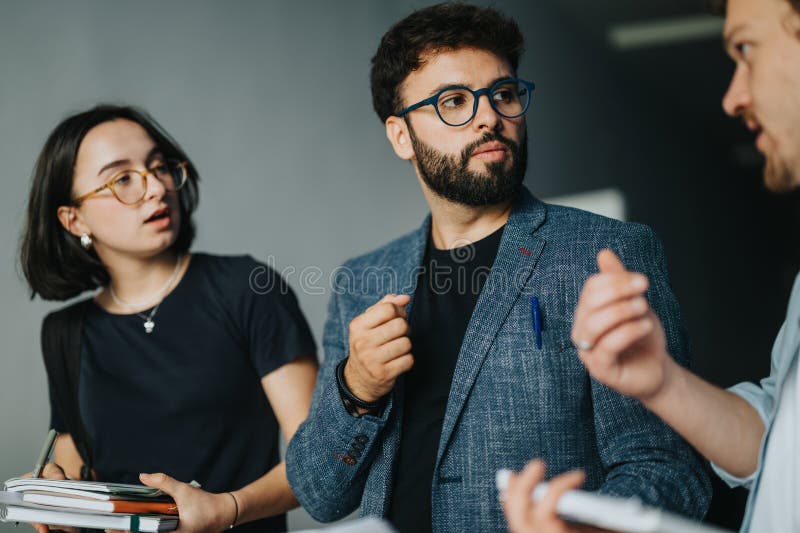 Engaged Students Conversing with Professor in University Corridor Stock ...