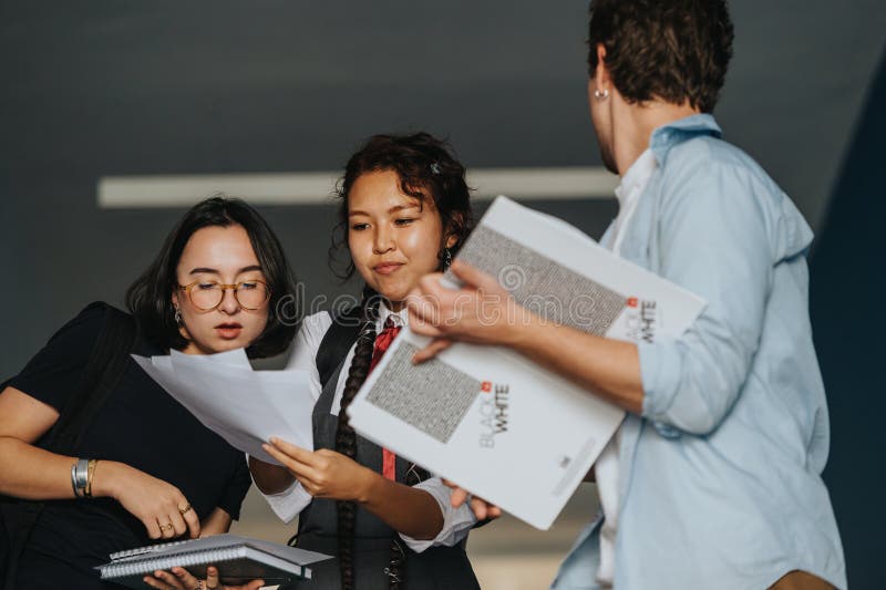 Engaged Students Discussing Notes with Their Professor Indoors Stock ...