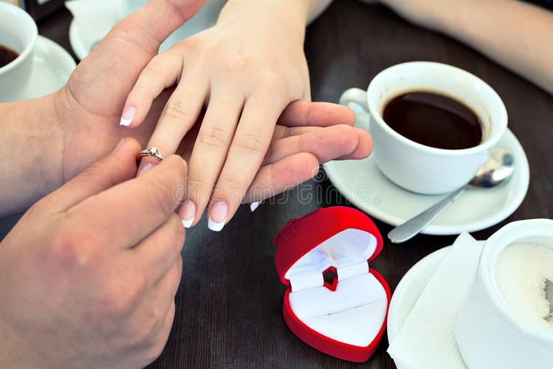 Engagement ring and coffee stock image. Image of holding - 56501427
