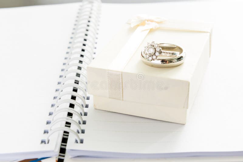 Engagement Ring and Gift Box on Note Book Stock Image - Image of metal ...