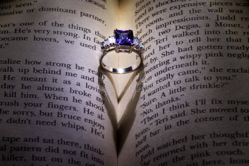 Engagement Ring Makes a Heart Shaped Silhouette on an Open Book Stock ...