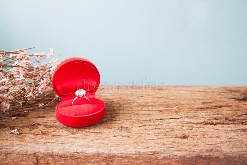 Engagement or Wedding Ring, Diamond Ring in Red Box on Wooden Ta Stock ...