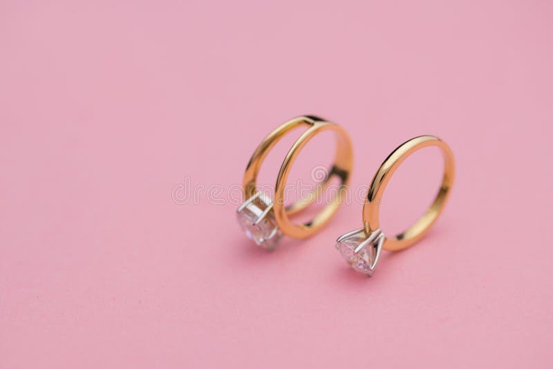 Engagement and Wedding Rings on Pink Background Stock Image - Image of ...