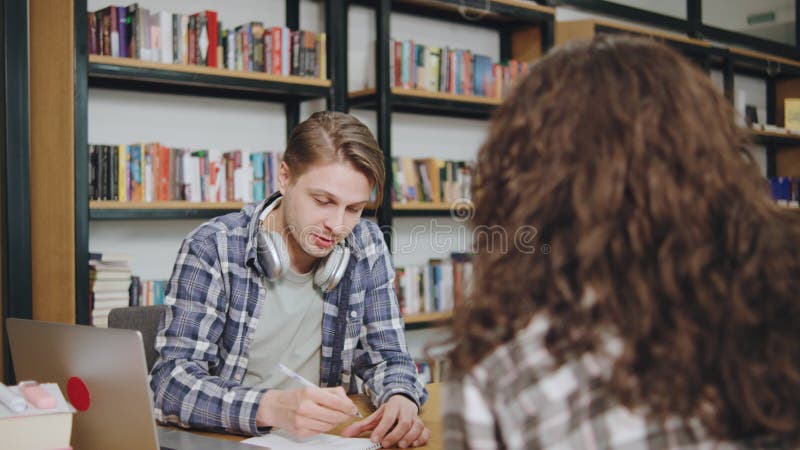 Engaging Conversation between a Young Man and Woman in a Library ...