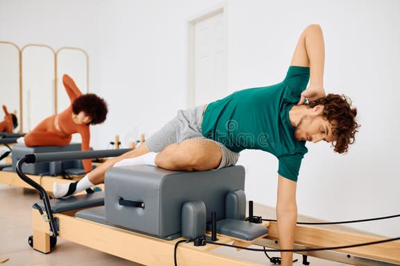 Engaging in Dynamic Pilates Exercises at Stock Image - Image of ...