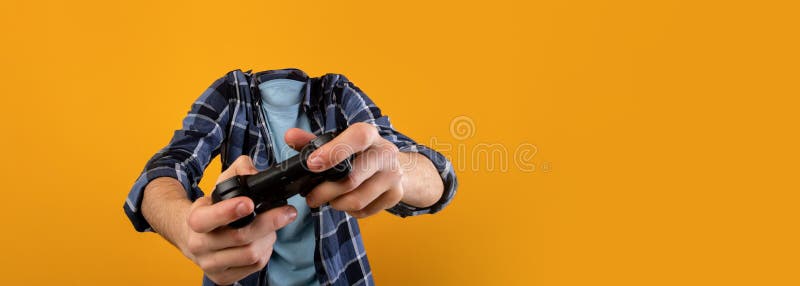Engaging in Gaming Activity Against a Bright Yellow Background for ...