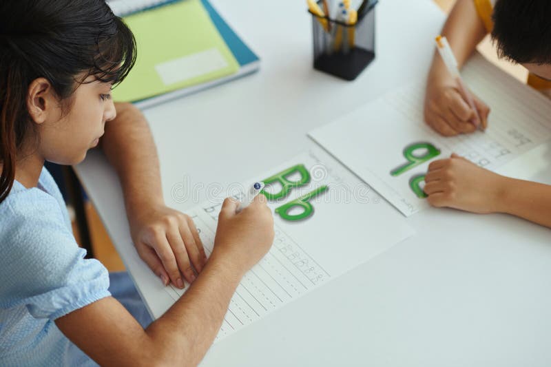 Engaging in Handwriting Practice in Classroom Setting Together Stock ...