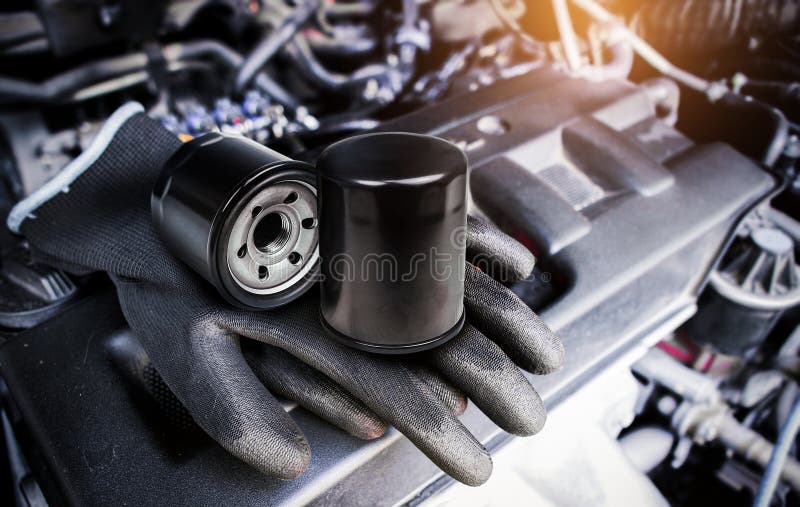 Engine Oil Filter and Auto Mechanic Gloves on Engine Cover in a Engine ...