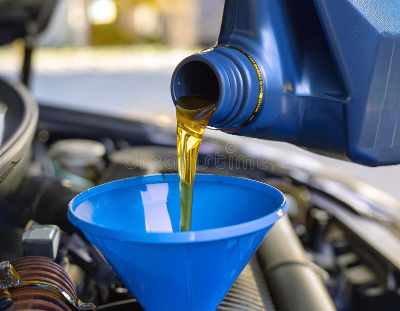 Engine Oil Pouring from a Blue Container into a Funnel, Above a Car ...