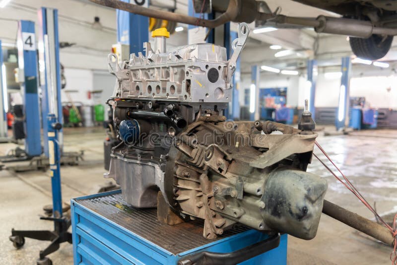 The Engine Removed from the Car with the Gearbox is on the Table in the ...