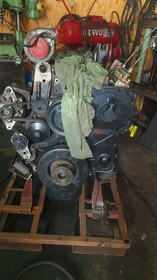 Engine Repair Process in a Workshop with Tools and Equipment Scattered ...