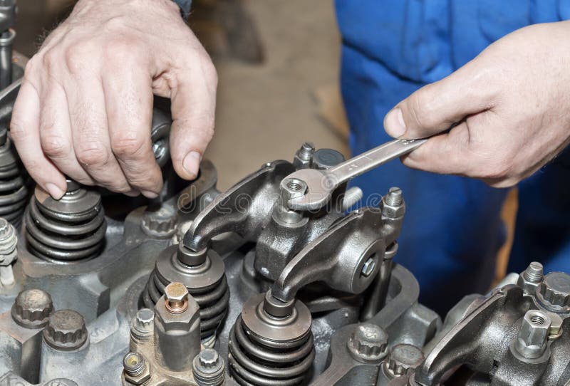 DIY ATV Engine Repair in the Garage. a Man is Replacing Broken Parts on ...