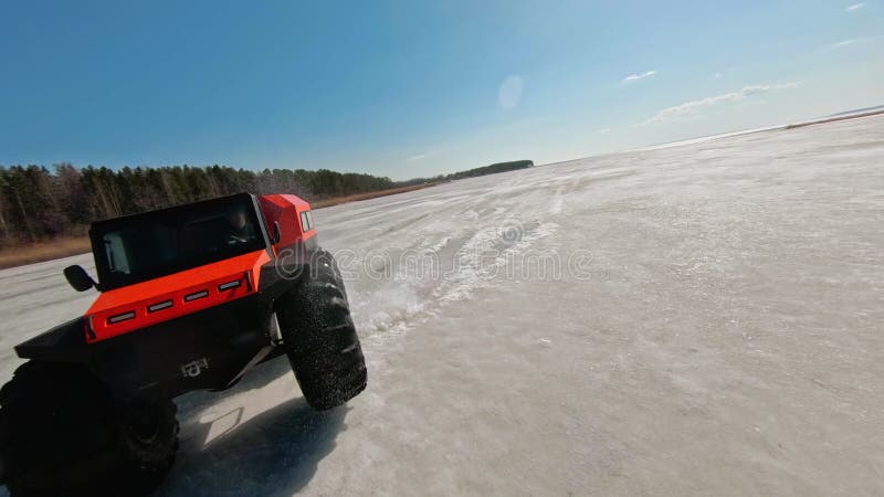 A Four-wheel-drive SUV Traverses the Fragile Spring Ice. 4WD Vehicle ...