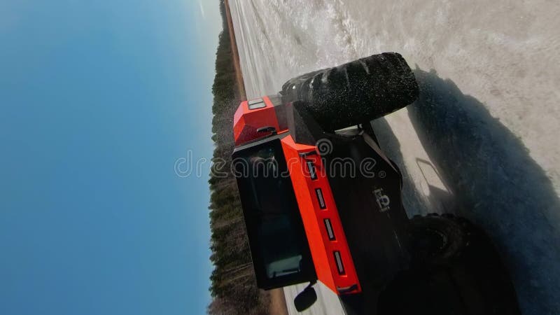 A Four-wheel-drive SUV Traverses the Fragile Spring Ice. 4WD Vehicle ...