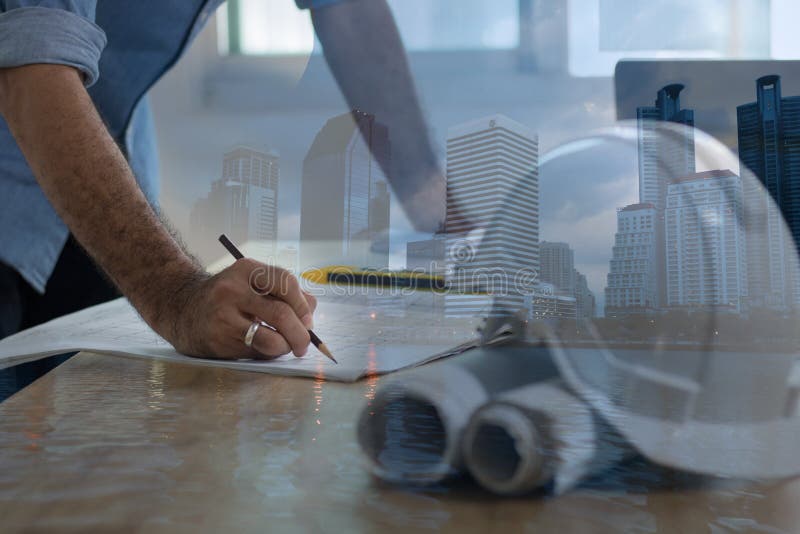 Enginee or Architect Drawing and Writing on Plan Paper on Desk, Stock ...