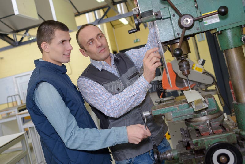 Engineer and Apprentice Using Automated Milling Machine Stock Image ...