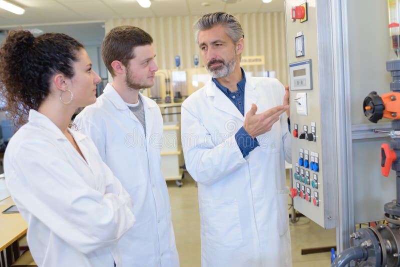 Engineer and Apprentice Using Computerized Cutting Machine Stock Image ...