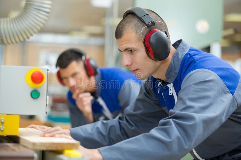 Engineer and Apprentice Using Computerized Cutting Machine Stock Photo ...