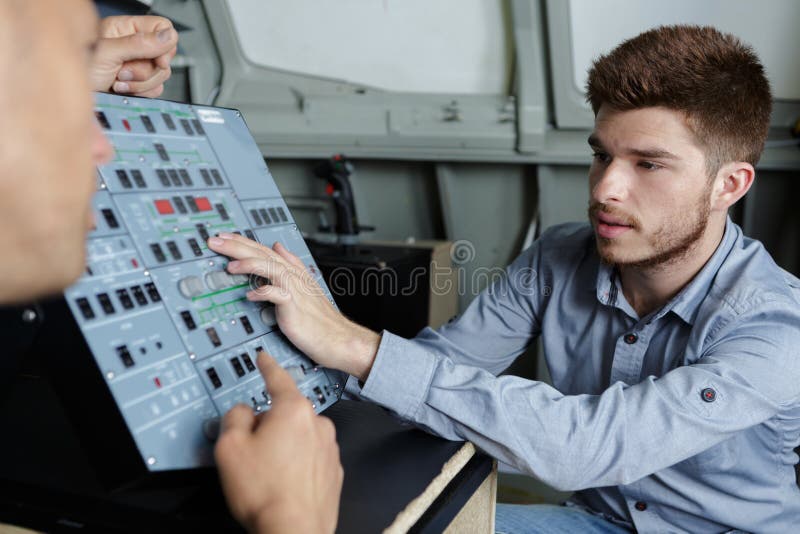 Engineer and Apprentice Using Computerized Cutting Machine Stock Image ...
