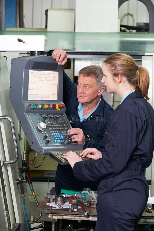Engineer and Apprentice Using Computerized Cutting Machine Stock Image ...