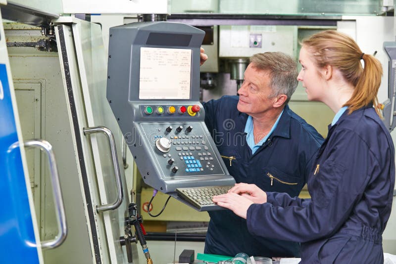 Engineer and Apprentice Using Computerized Cutting Machine Stock Image ...