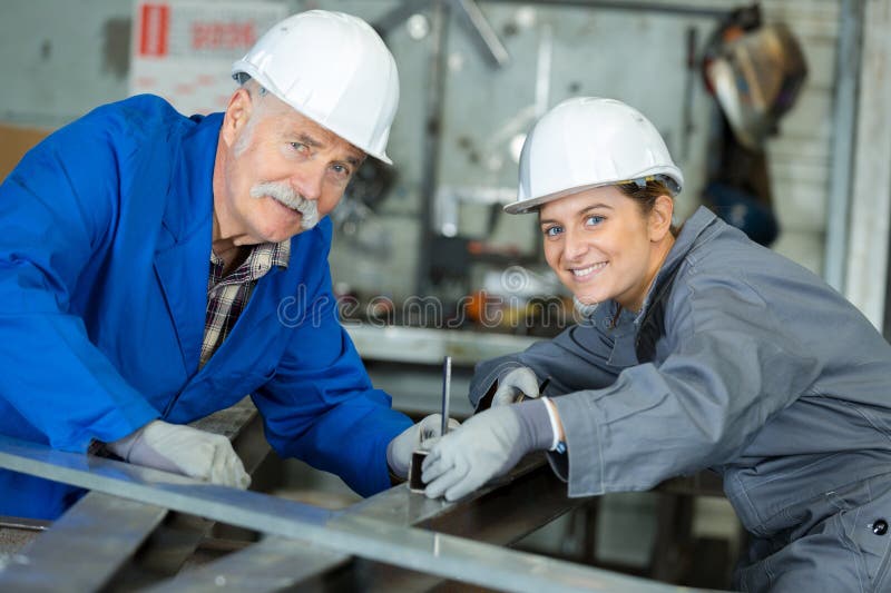 Engineer and Apprentice Using Cutting Machine Stock Photo - Image of ...