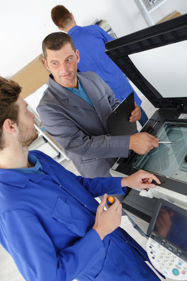 Engineer and Apprentice Working on Machine in Office Stock Photo ...
