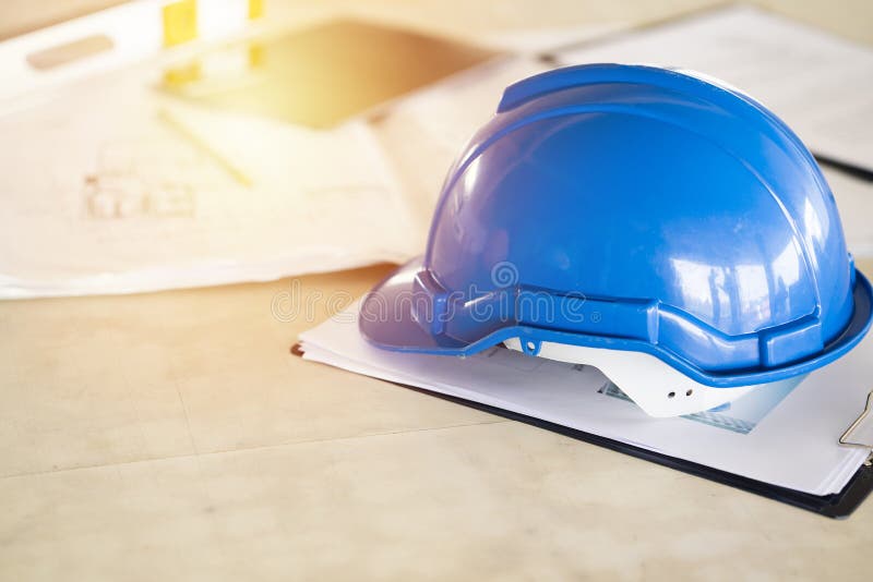 Engineer or Architect Desk with Blue Helmet on the Table in the Office ...
