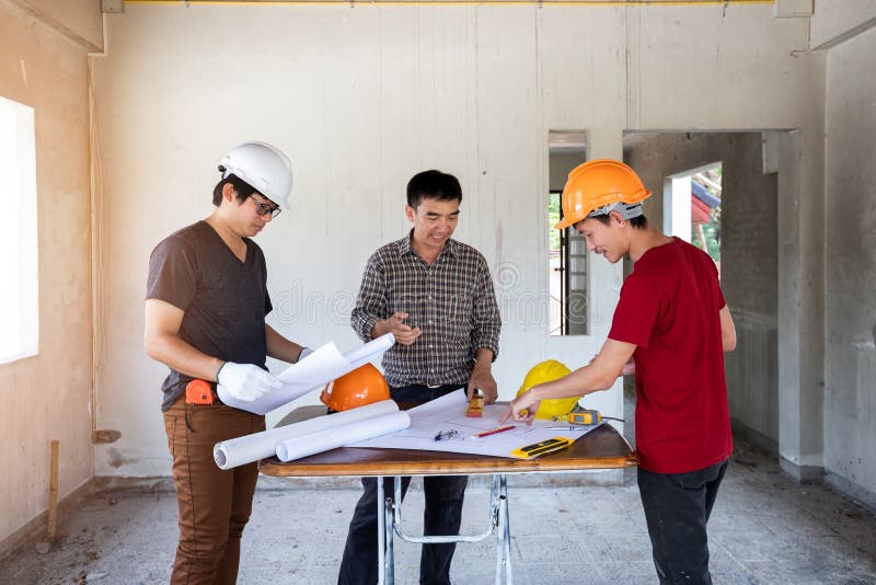 Engineer and Architect Discussing with Foreman about Project in ...