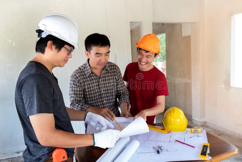 Engineer and Architect Discussing with Foreman about Project in ...