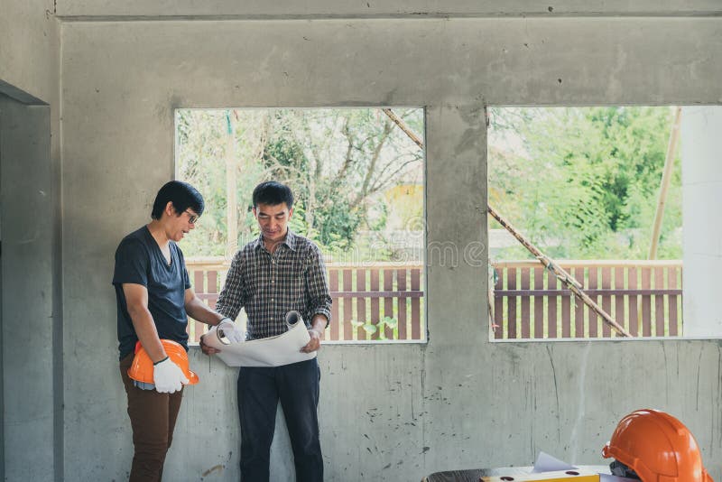 Engineer and Architect Discussing with Foreman about Project in ...