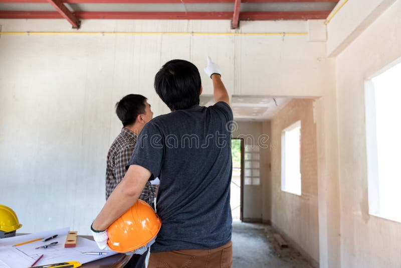 Engineer or Architect Discussing with Foreman about Project in Building ...