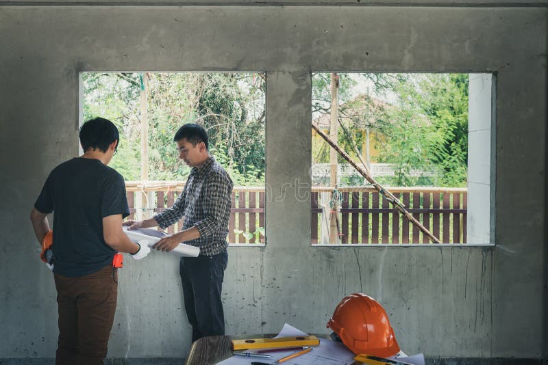 Engineer and Architect Discussing with Foreman about Project in ...