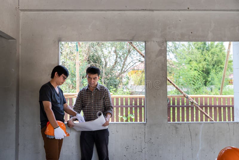 Engineer and Architect Discussing with Foreman about Project in ...