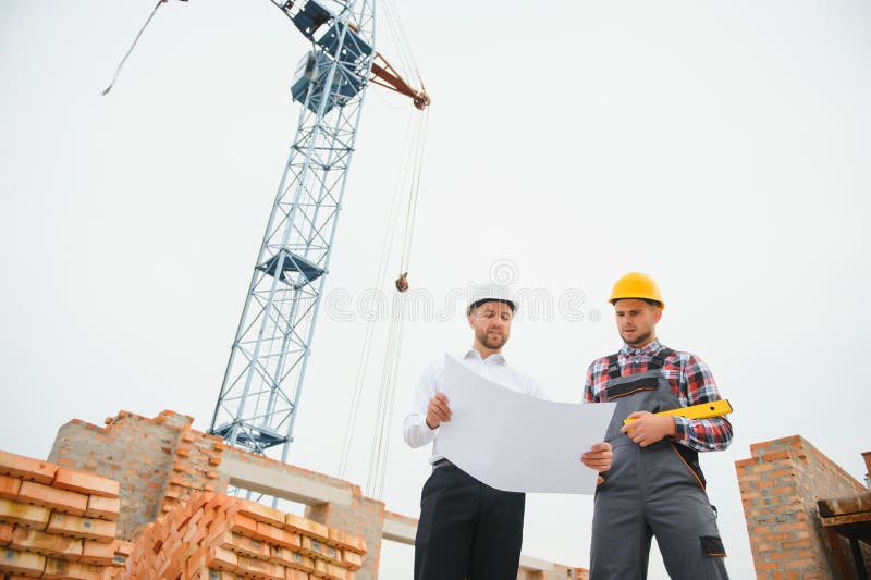 Engineer Architect with Hard Hat and Safety Vest Working Together in ...