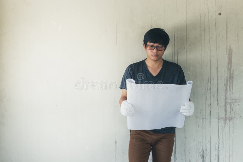 Engineer or Architect Holding Blueprint in Building Construction Site ...