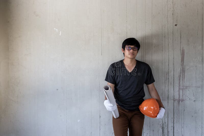 Engineer or Architect Holding Blueprint and Helmet in Building ...