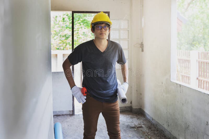 Engineer or Architect Holding Blueprint and Helmet in Building ...