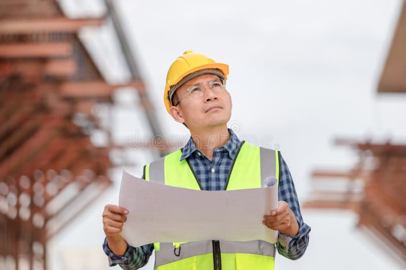 Engineer or Architect Man in Hard Hat Holding a Blueprint at ...