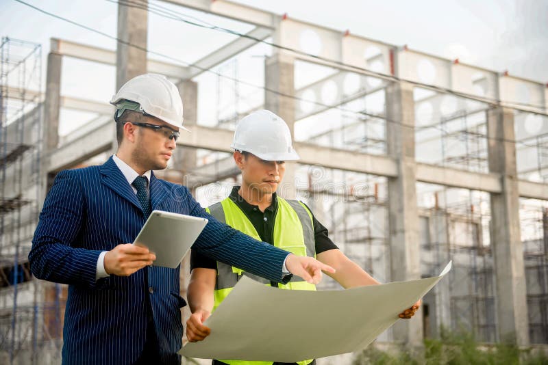 Engineer and Architect Monitor the Progress of Building Construction ...