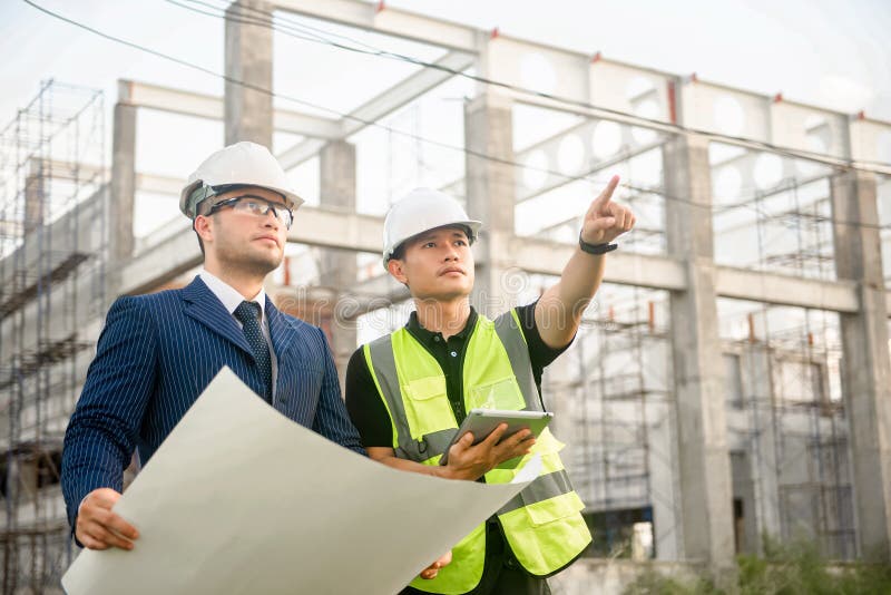Engineer and Architect Monitor the Progress of Building Construction ...