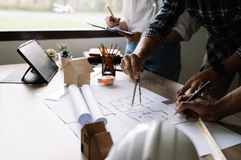 Engineer and Architect People Meeting Working and Hand Drawing on ...