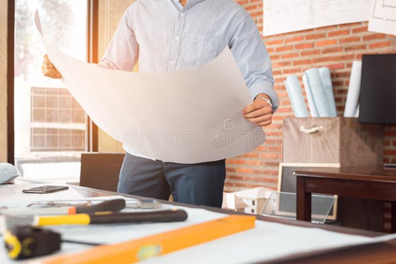 Engineer or Architect is Reading Paper Blueprint Project Plan. Civil ...