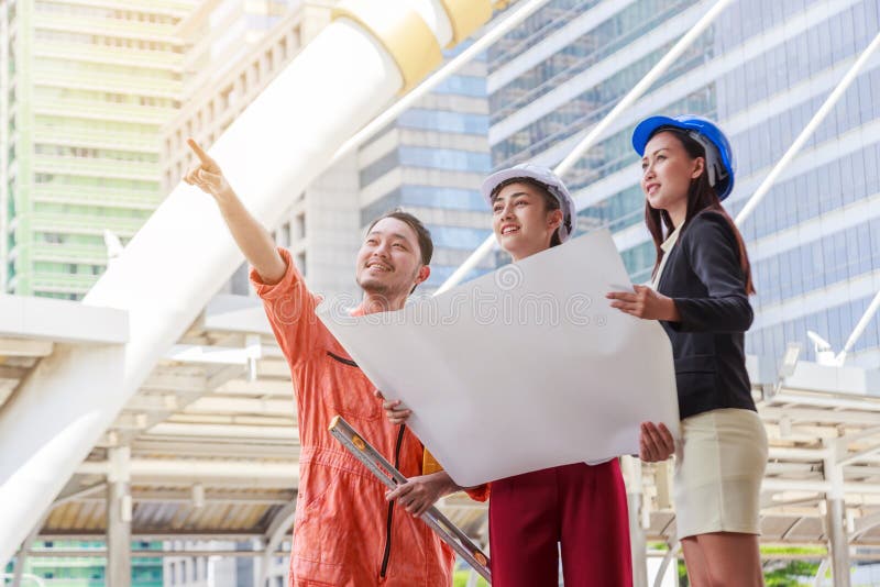 Engineer or Architect Team and Worker Looking Paper Plans Stock Image ...